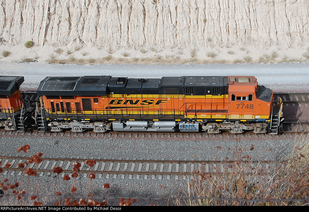 BNSF ES-44DC #7748 is part of a DPU set on a westbound